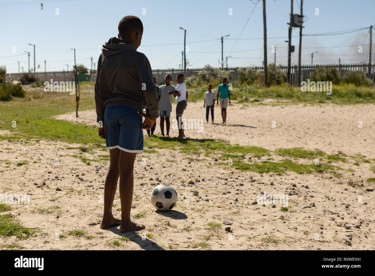 Kids playing football in the ground Stock Photo - Alamy