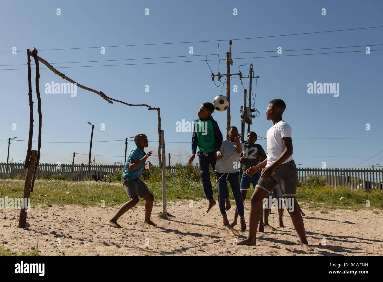 Kids playing football in the ground Stock Photo - Alamy