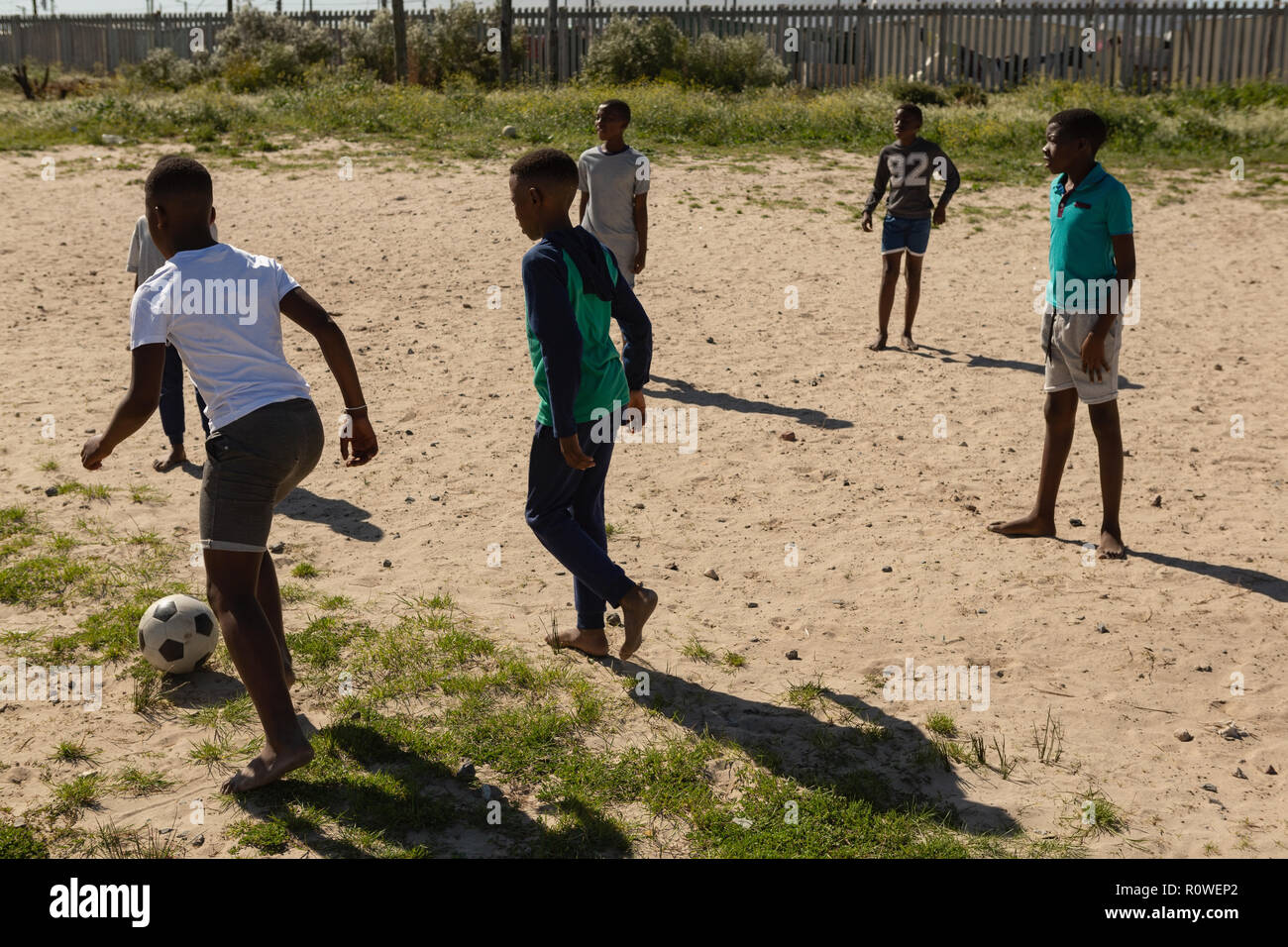 Kids playing football in the ground Stock Photo - Alamy