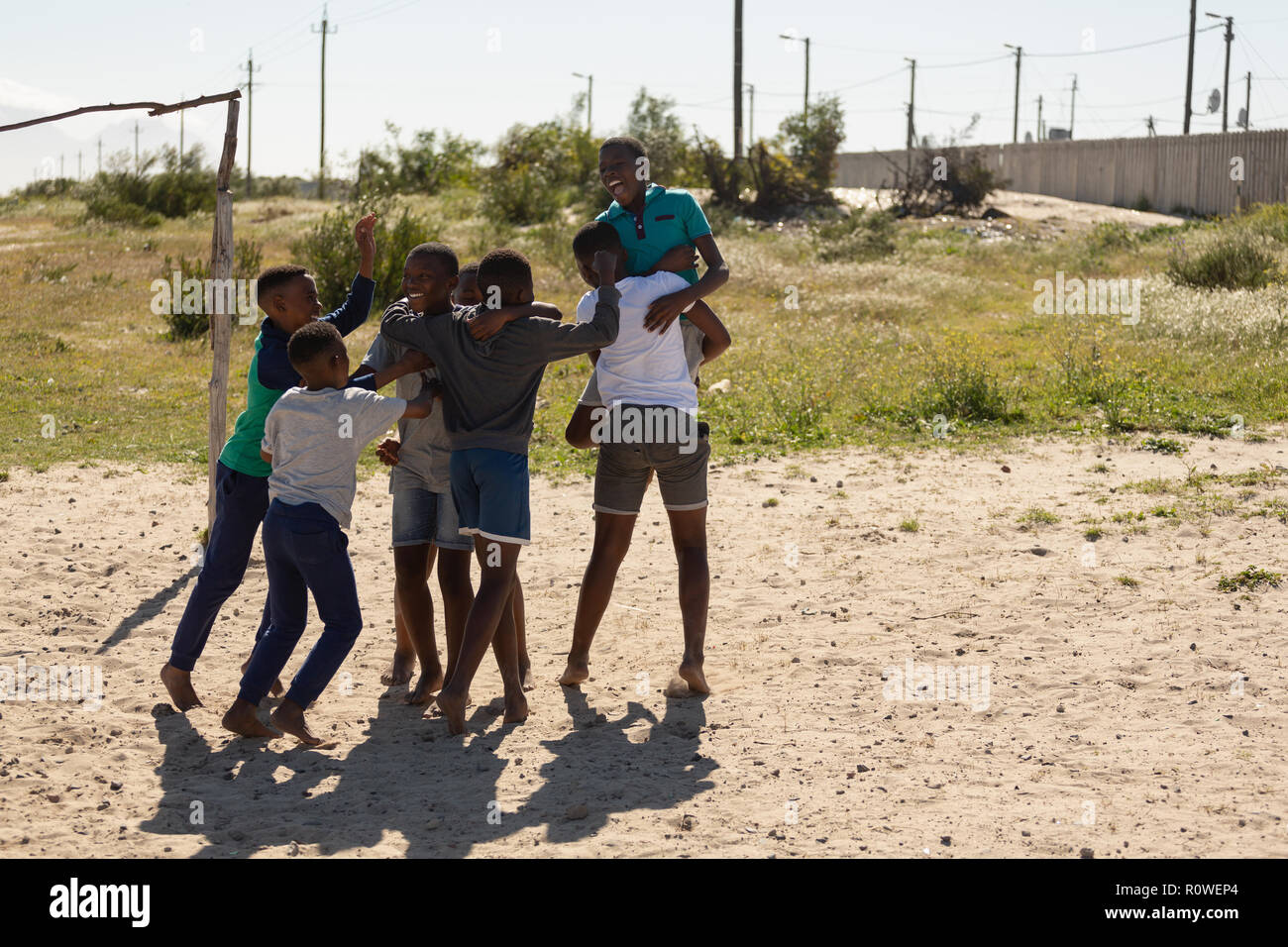 Kids playing football in the ground Stock Photo - Alamy