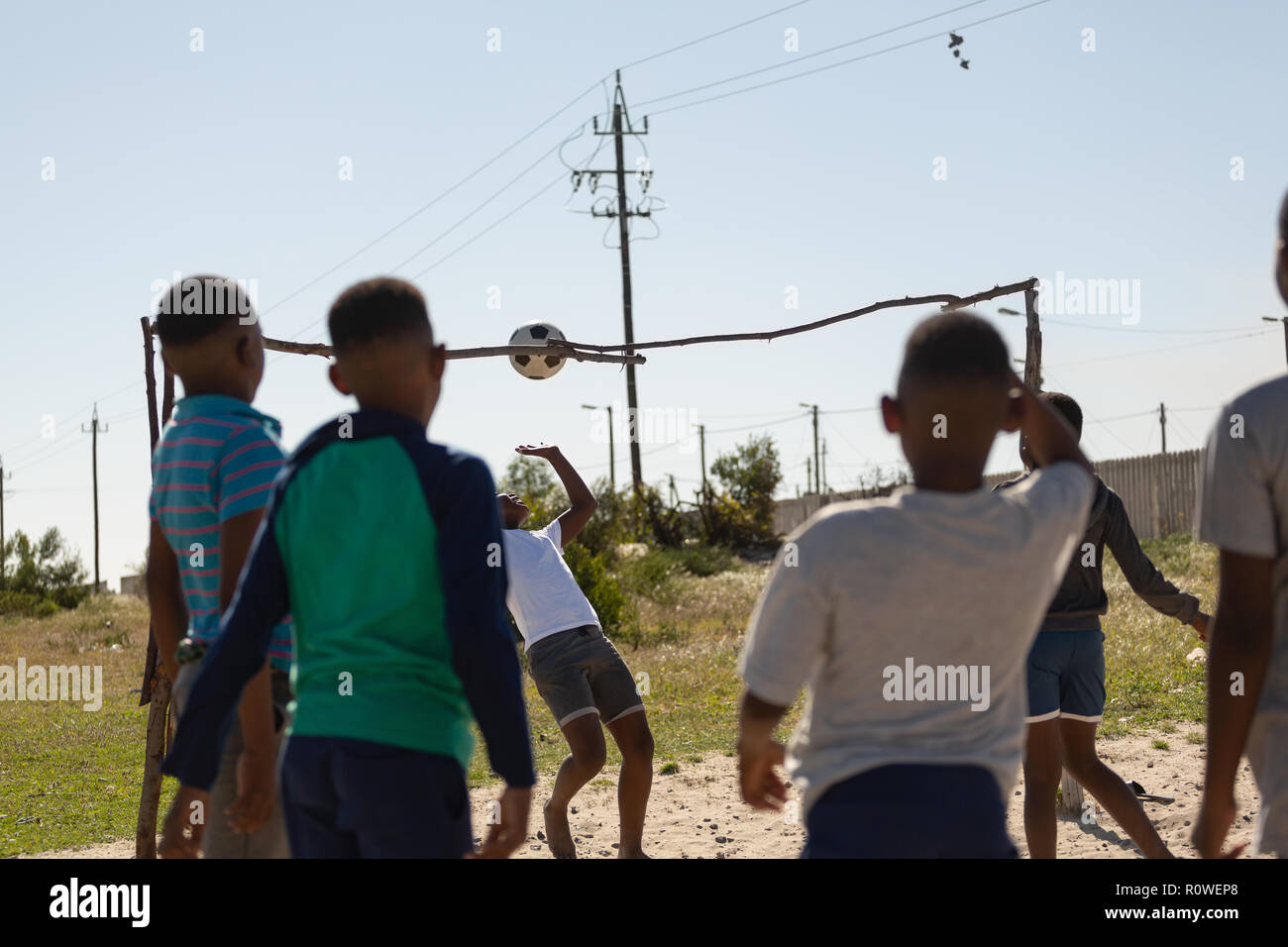 Kids playing football in the ground Stock Photo - Alamy