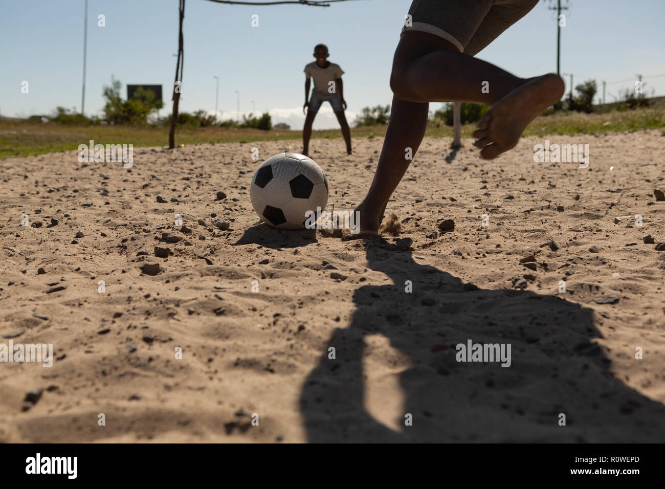 Kids playing football in the ground Stock Photo - Alamy