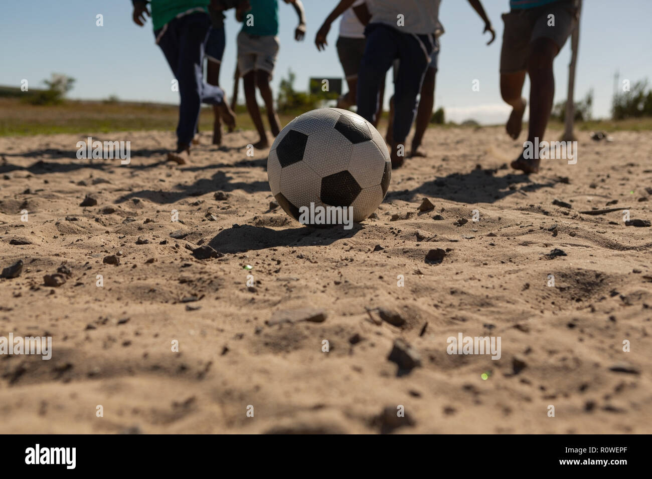 Kids playing football in the ground Stock Photo - Alamy