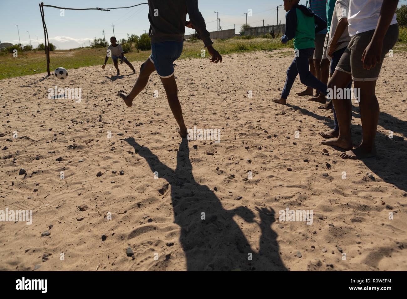 Kids playing football in the ground Stock Photo - Alamy