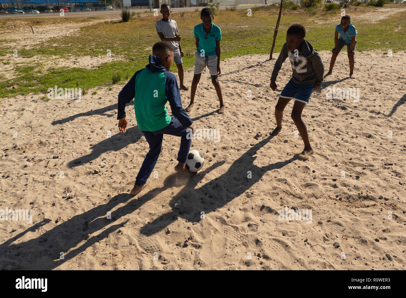 Kids playing football in the ground Stock Photo - Alamy