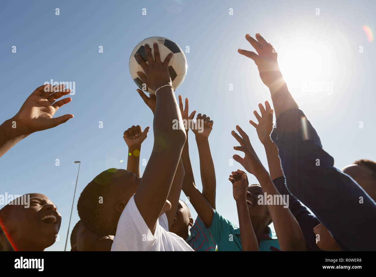 Kids playing football in the ground Stock Photo - Alamy