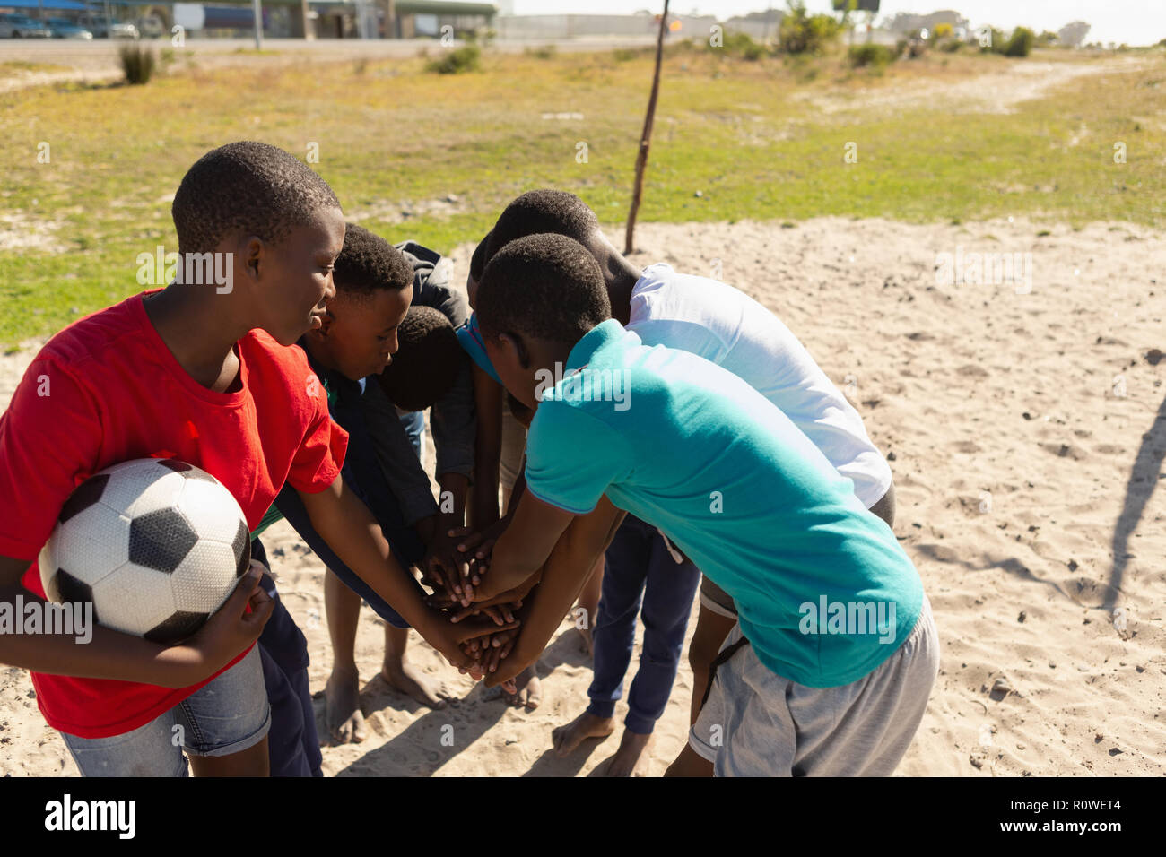 Kids forming hands stack in the ground Stock Photo - Alamy
