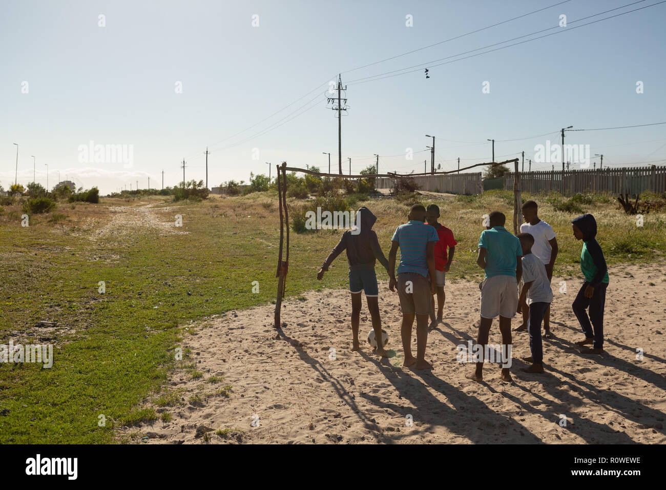 Kids playing football in the ground Stock Photo - Alamy