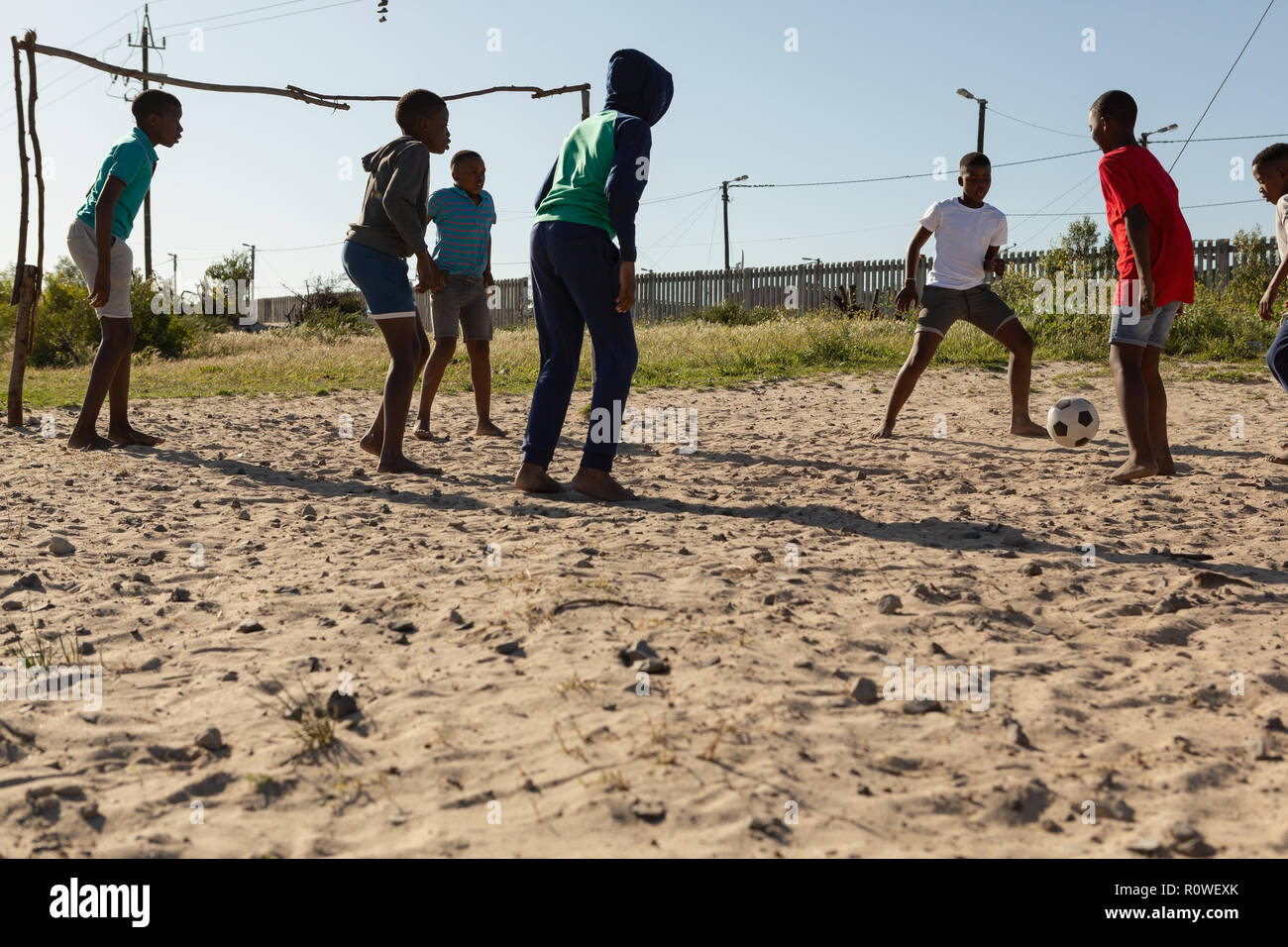 Kids playing football in the ground Stock Photo - Alamy