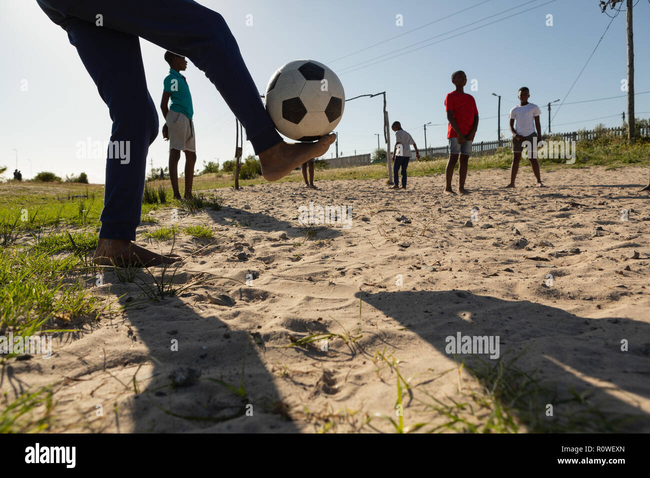 Kids playing football in the ground Stock Photo - Alamy