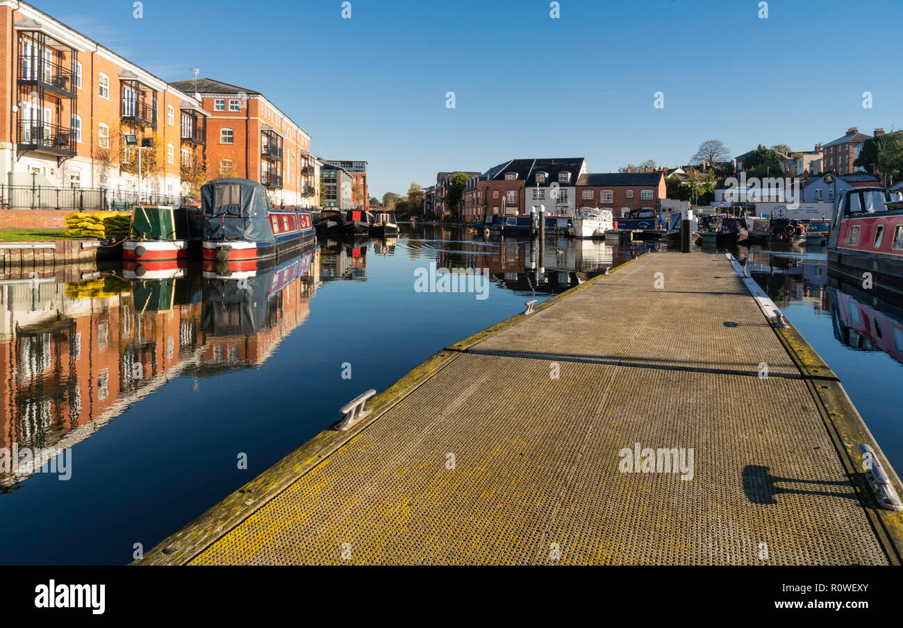 Reflections of barges and canal side buildings in the water at Diglis ...