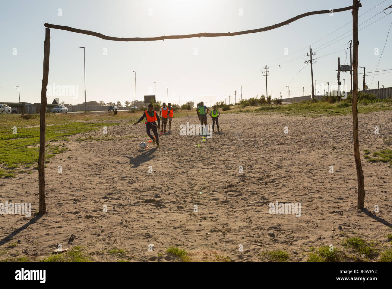 Kids playing football in the ground Stock Photo - Alamy