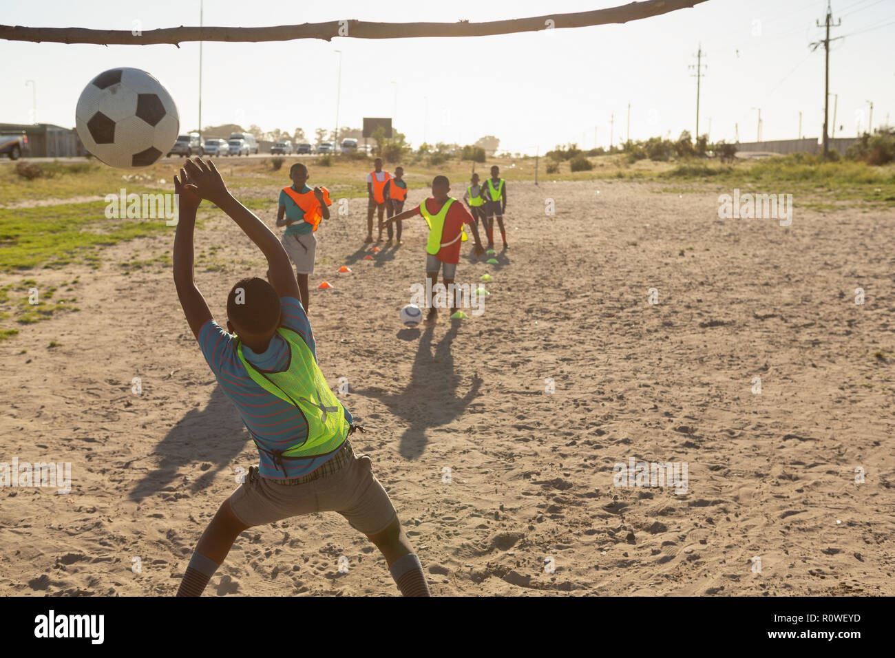 Kids playing football in the ground Stock Photo - Alamy