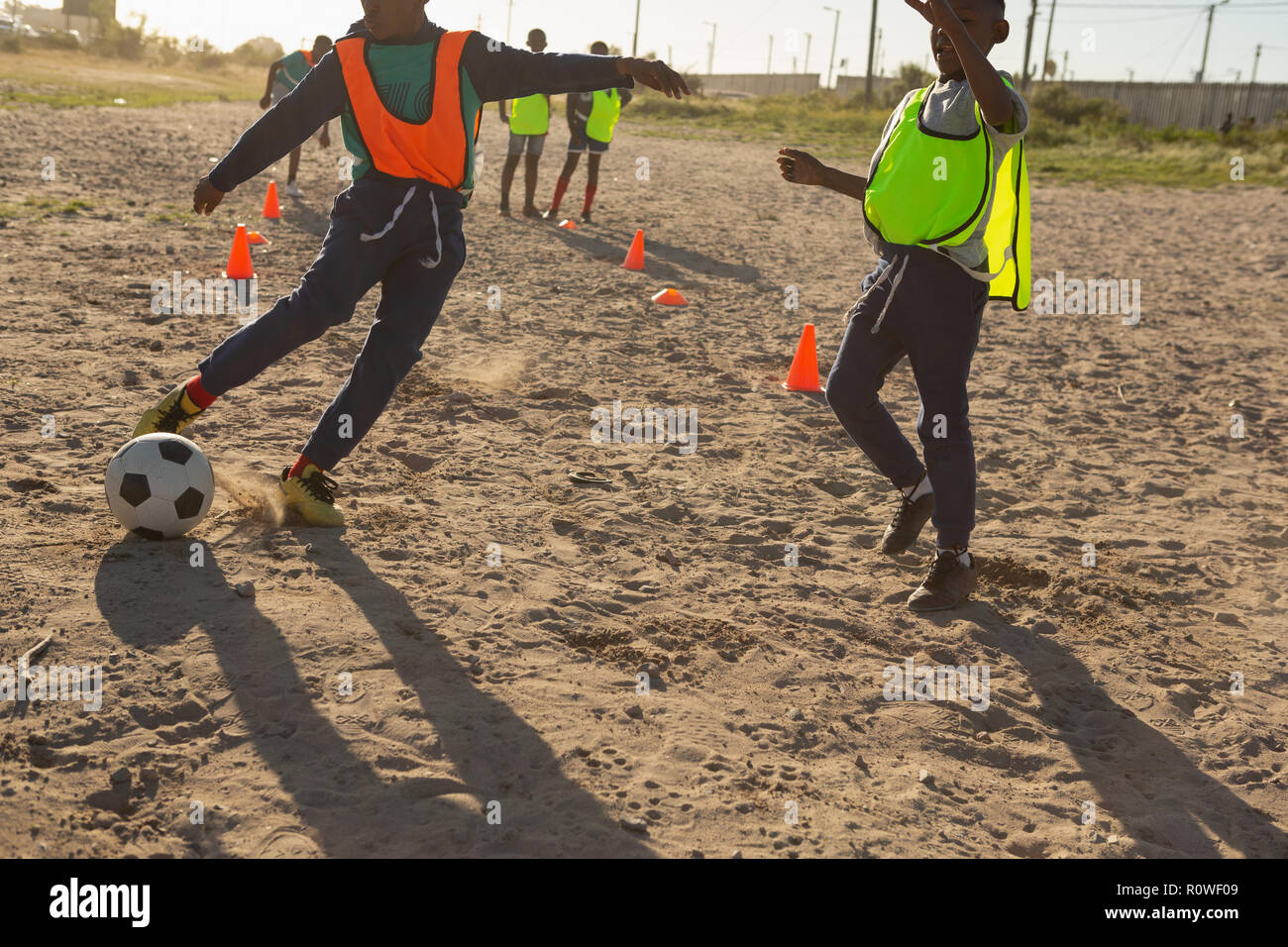 Kids playing football in the ground Stock Photo - Alamy
