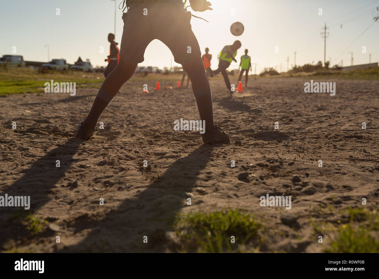Kids playing football in the ground Stock Photo - Alamy