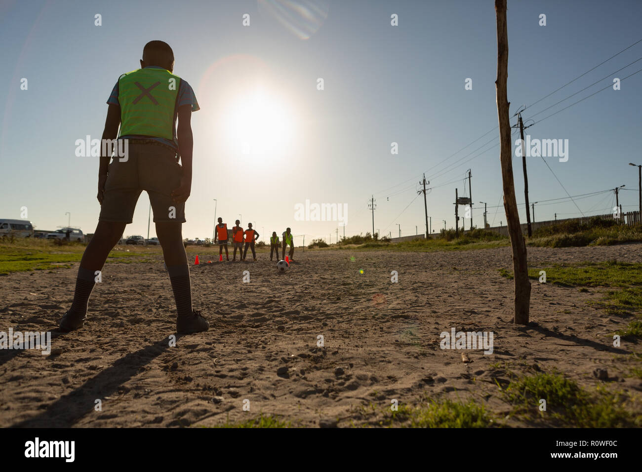 Kids playing football in the ground Stock Photo - Alamy