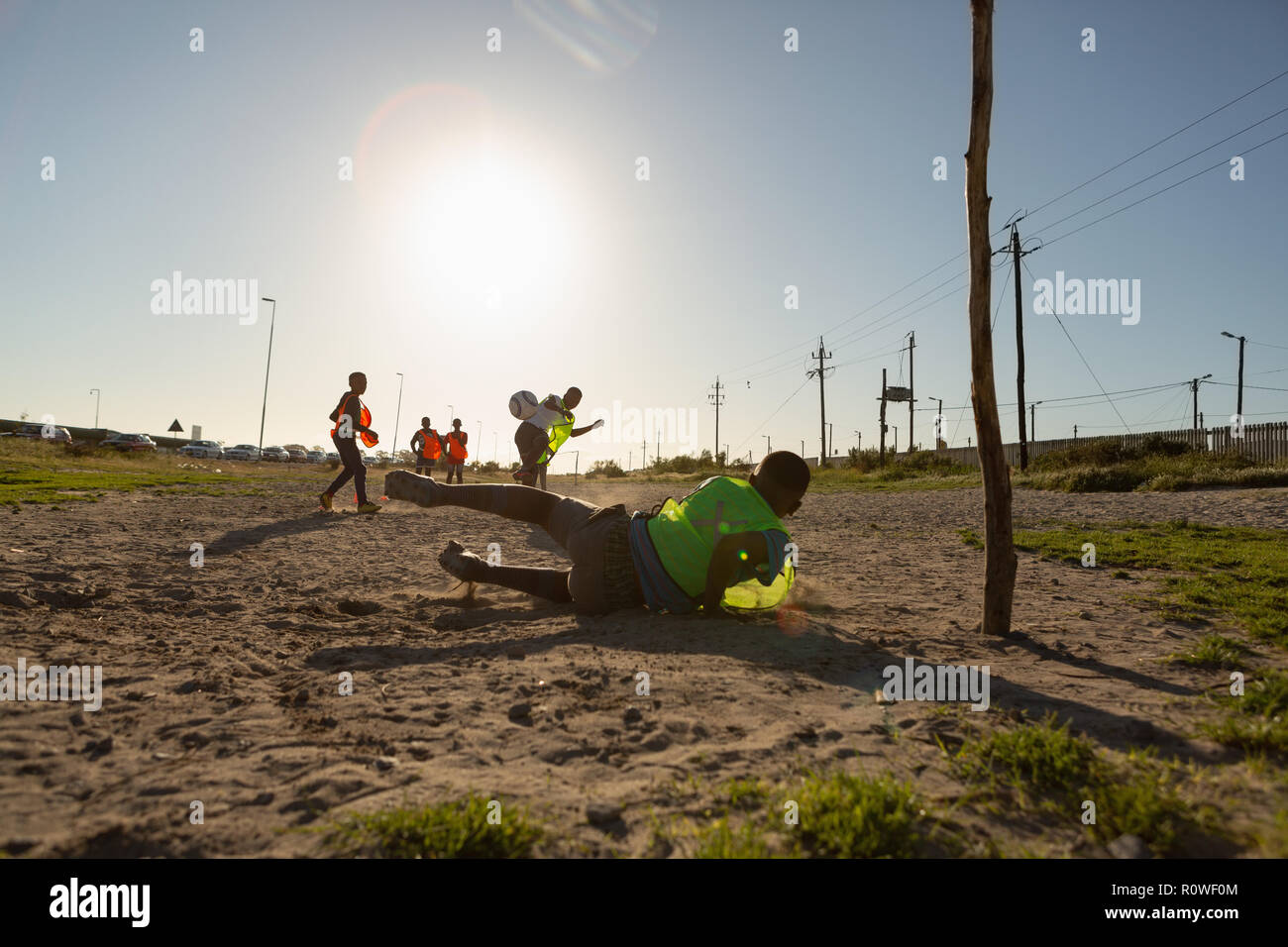 Kids playing football in the ground Stock Photo - Alamy