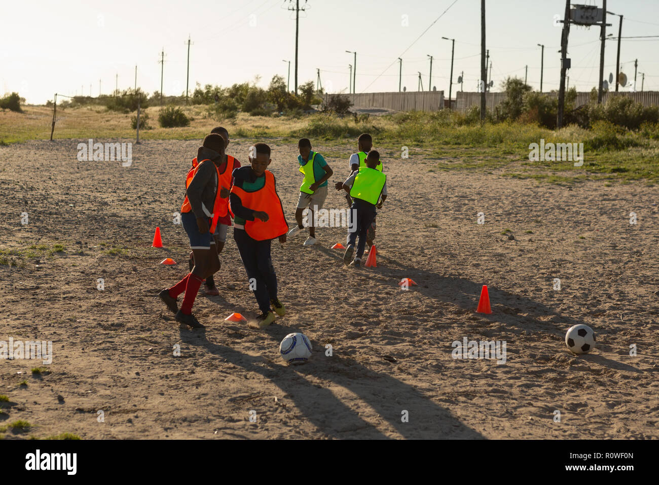 Kids playing football in the ground Stock Photo - Alamy