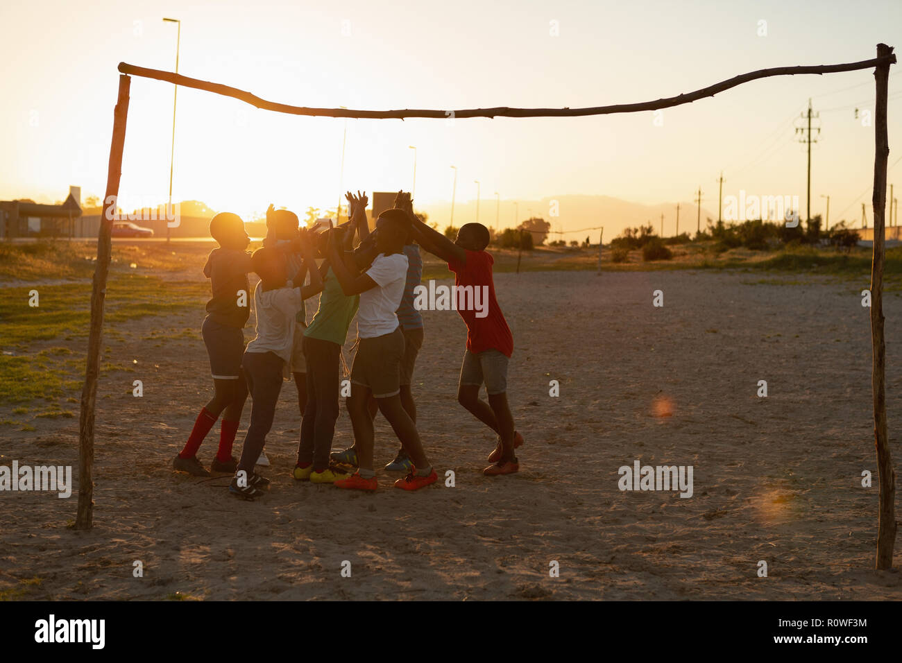 Kids playing football in the ground Stock Photo - Alamy
