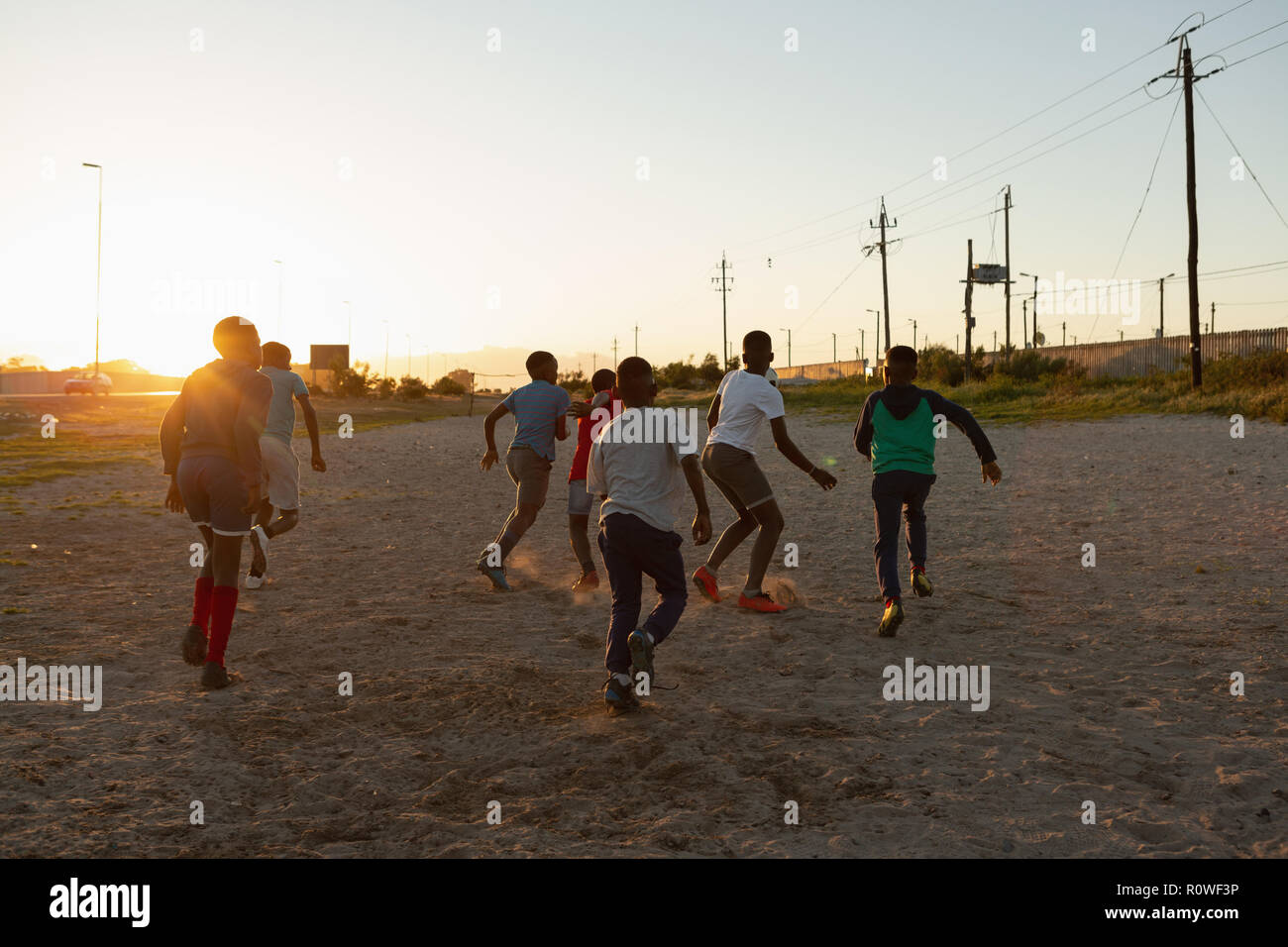 Kids playing football in the ground Stock Photo - Alamy