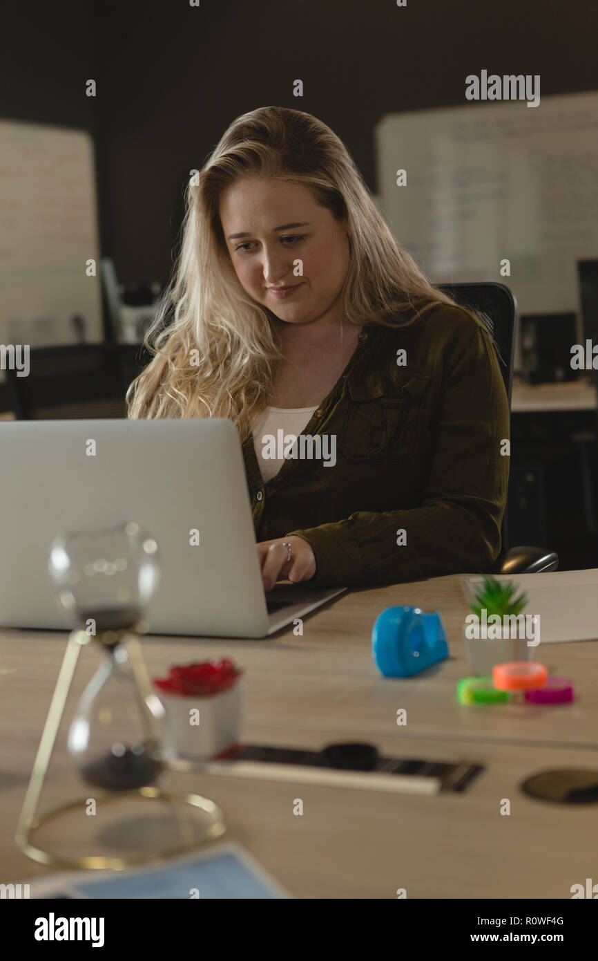 Executive using laptop in office Stock Photo - Alamy