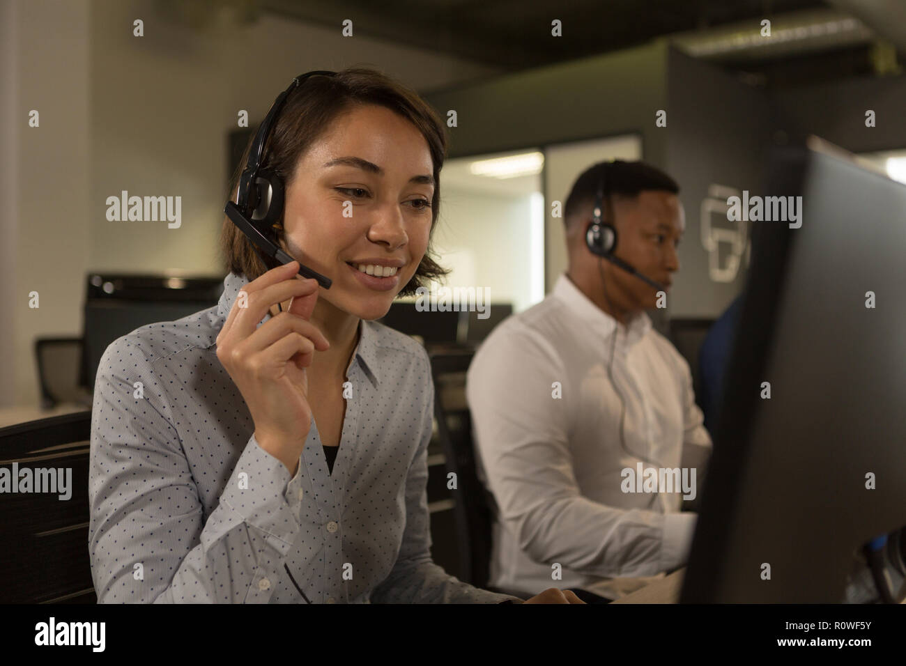 Customer service executives talking on headset at desk Stock Photo - Alamy