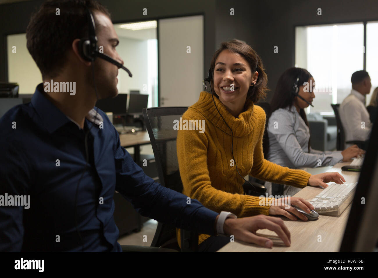 Business colleagues interacting other desk hi-res stock photography and ...