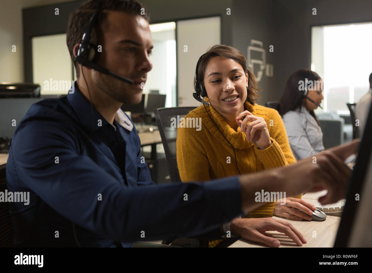 Customer service executives discussing over desktop pc Stock Photo - Alamy