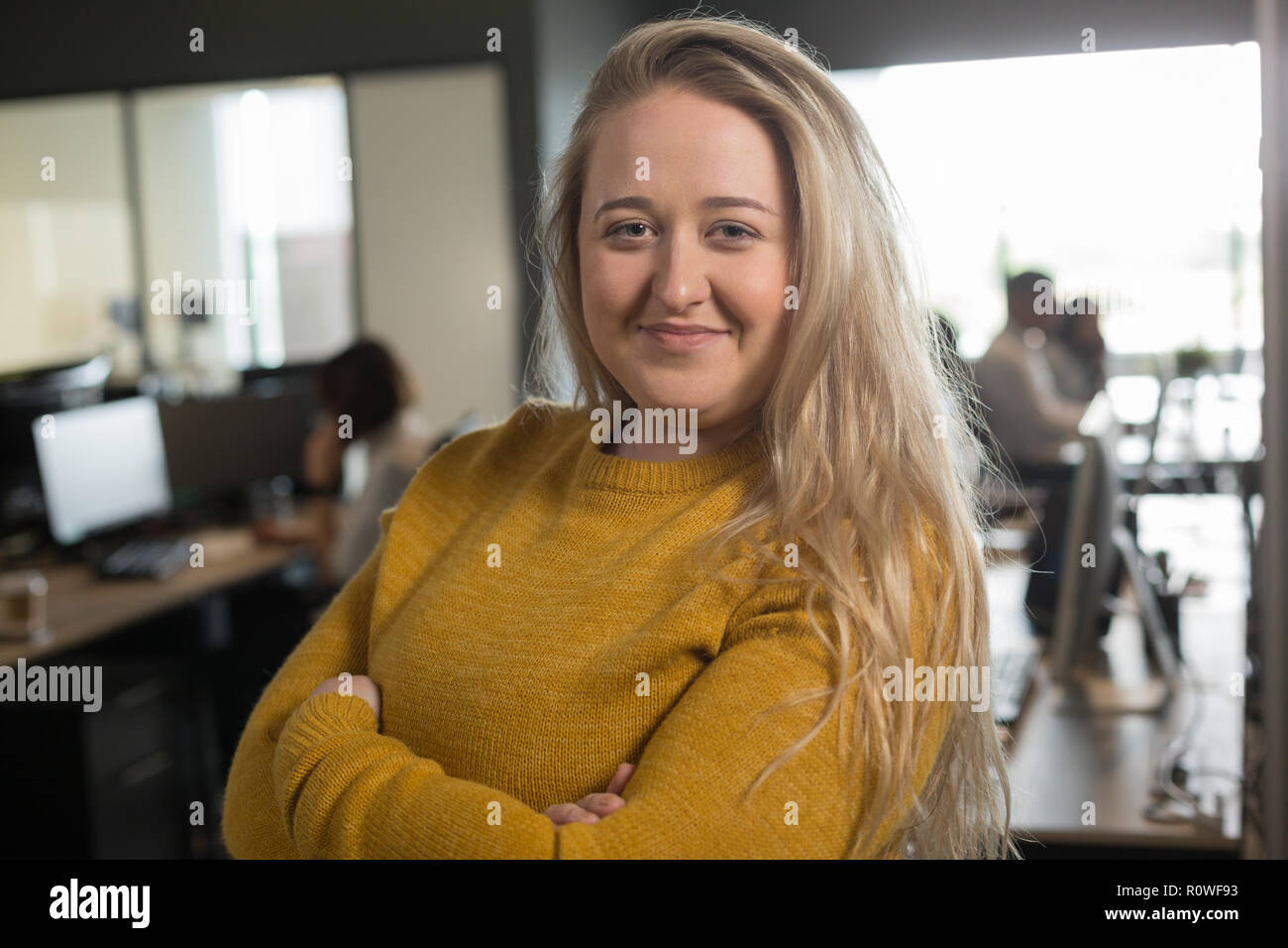 Female executive looking at camera in office Stock Photo - Alamy