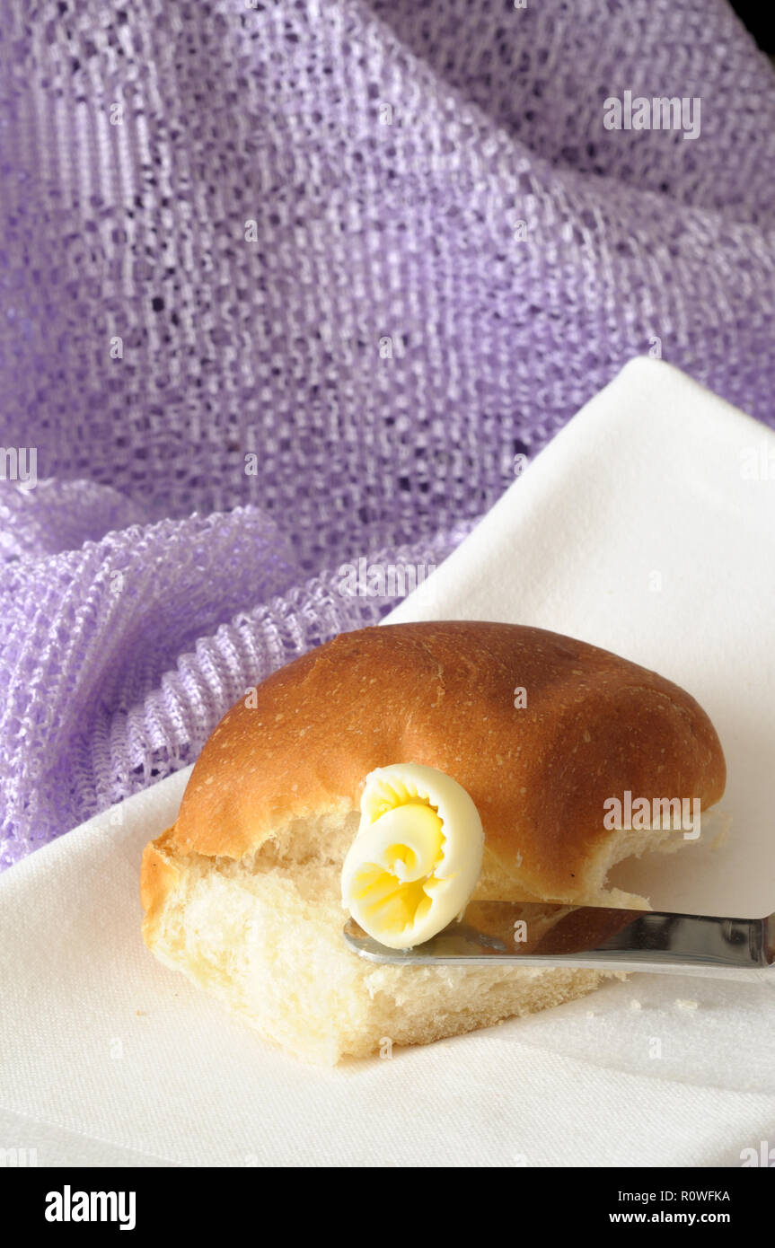 roll and curl butter, spreading butter on bread, vertical Stock Photo ...