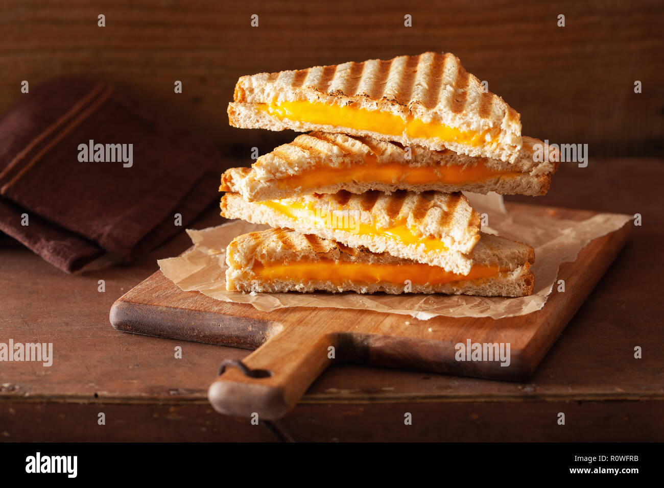 grilled cheese sandwich on rustic brown background Stock Photo - Alamy