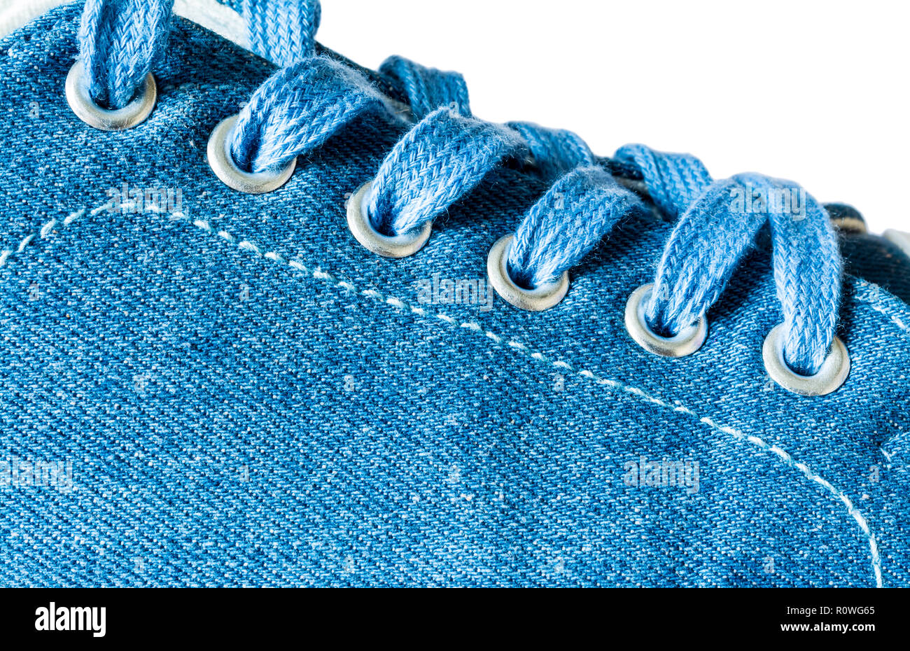 Denim sneakers close-up macro texture isolated on white background ...