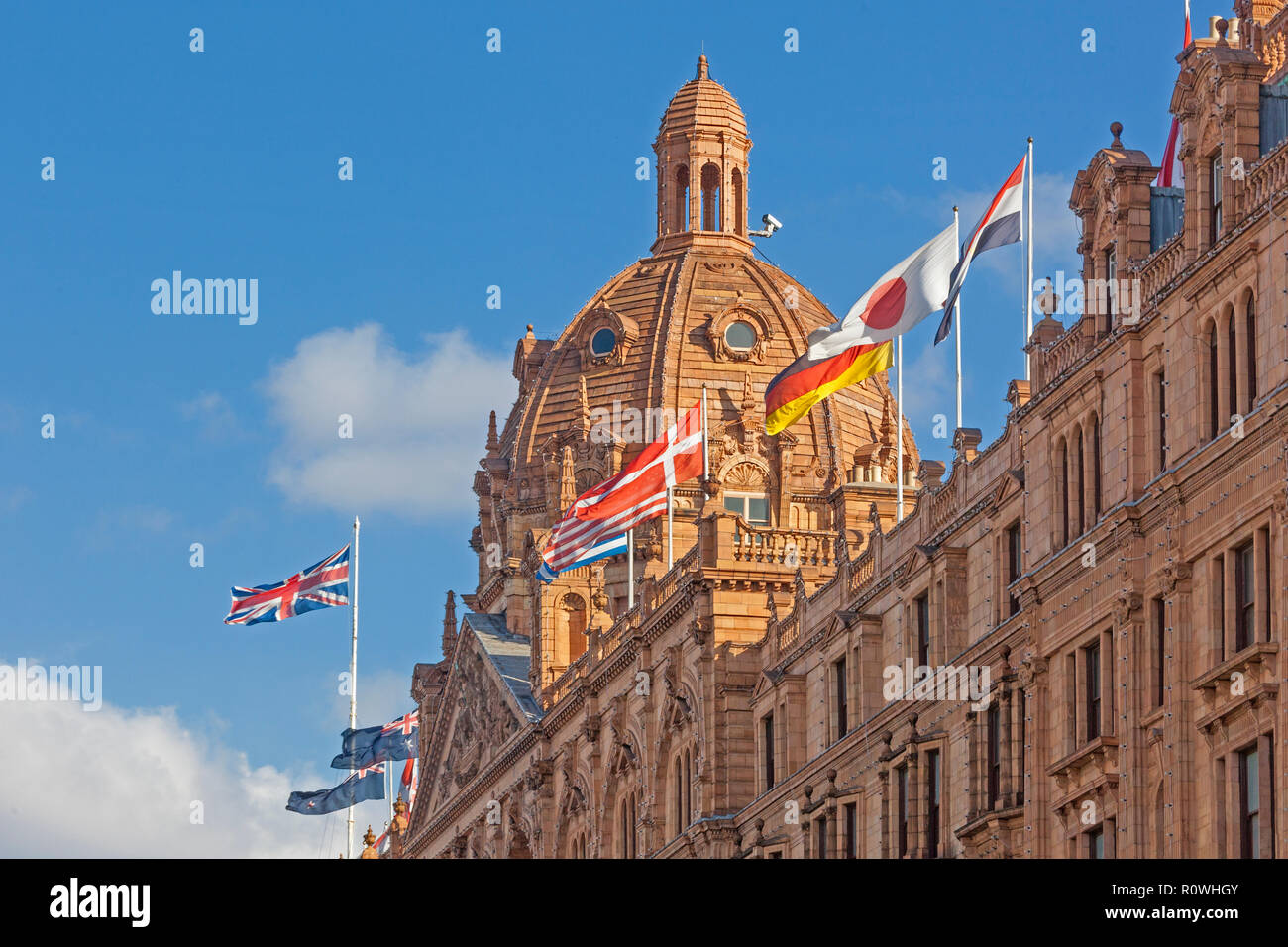 London, Knightsbridge. A variety of flags flying from the roof of ...