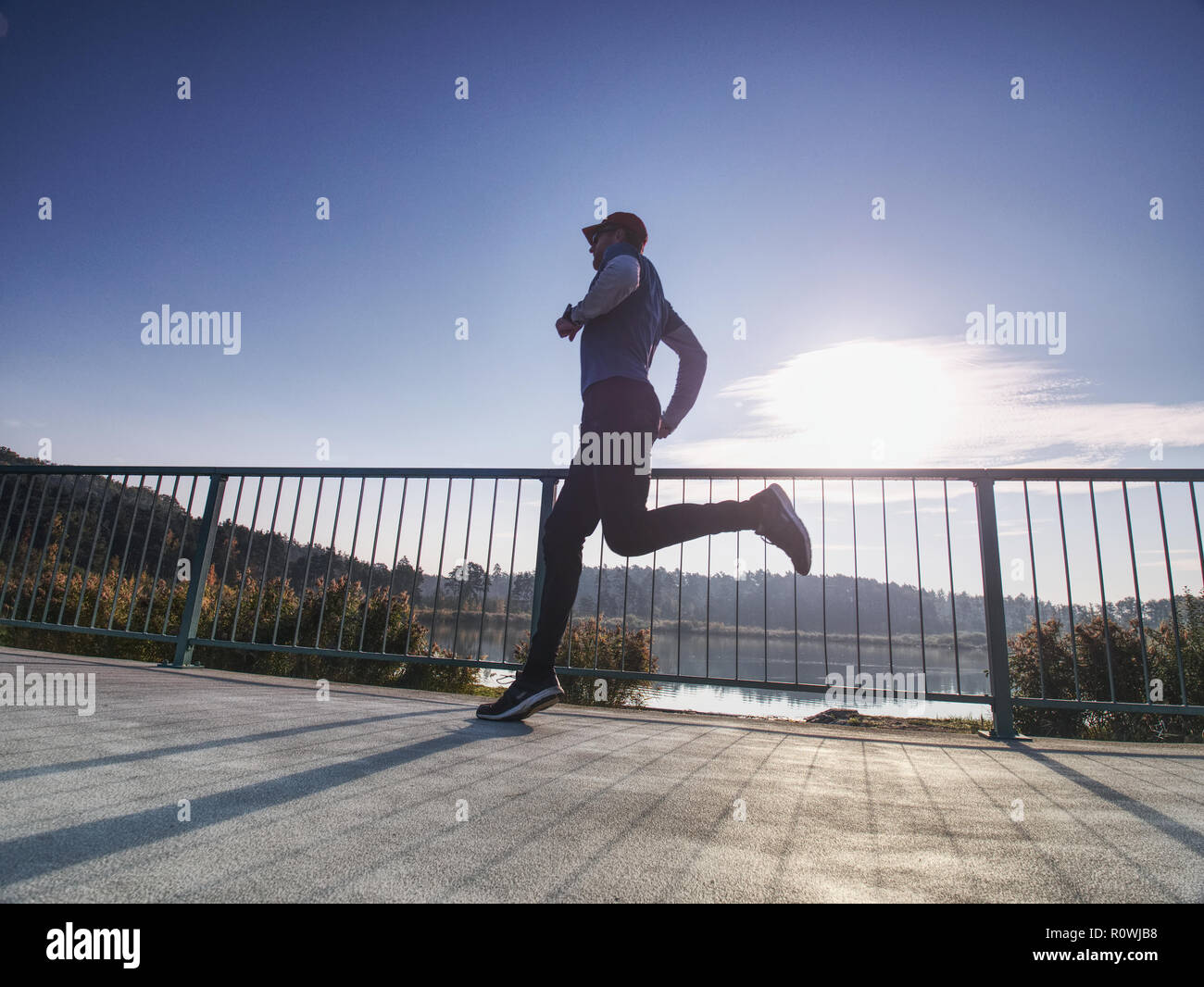 Running athlete man, side full body view. Male runner sprinting during ...