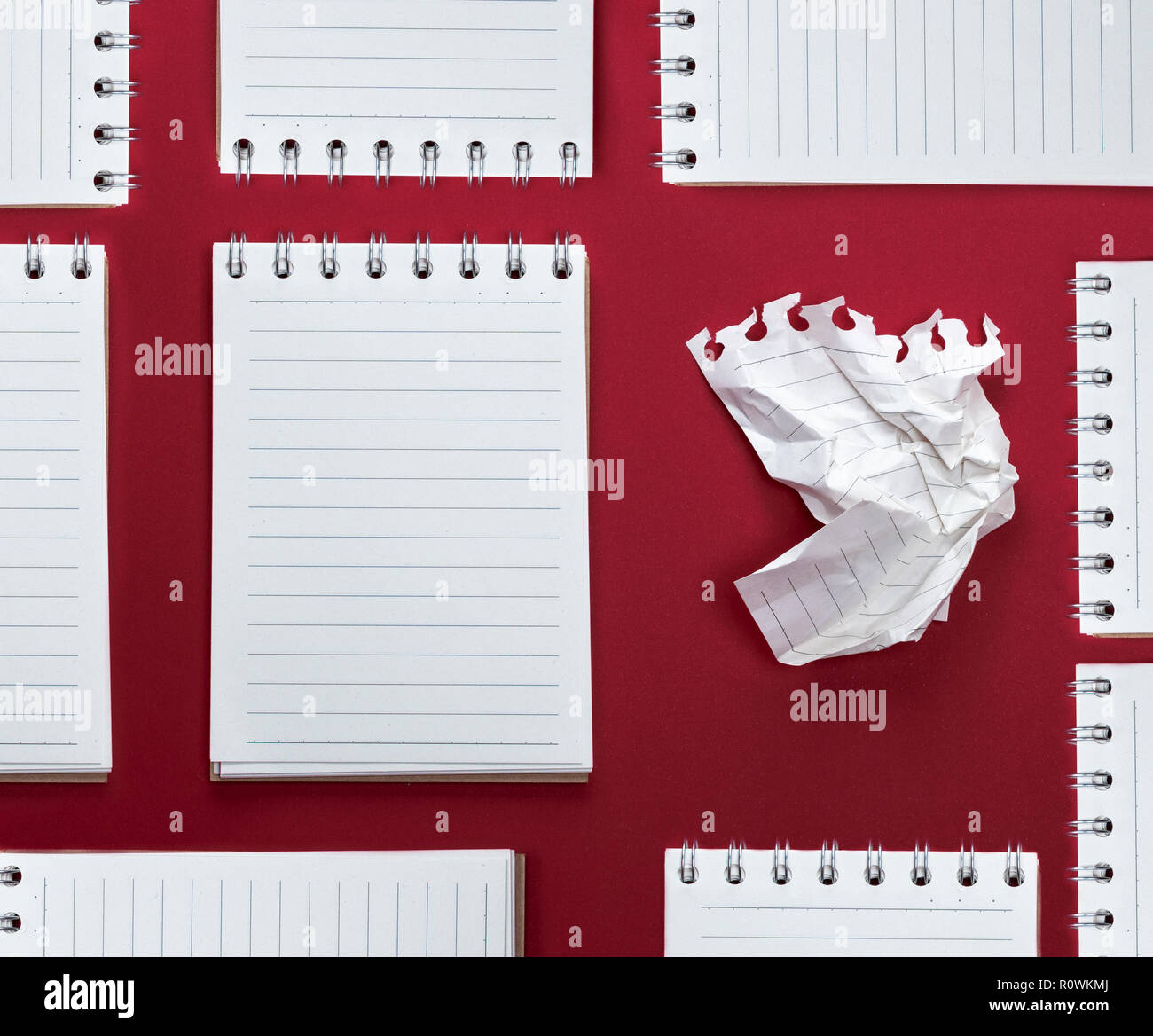 abstract red background with many notebooks with blank sheets in line ...