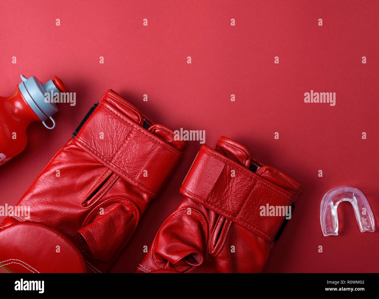 red leather boxing gloves, a plastic water bottle and silicone cap for ...