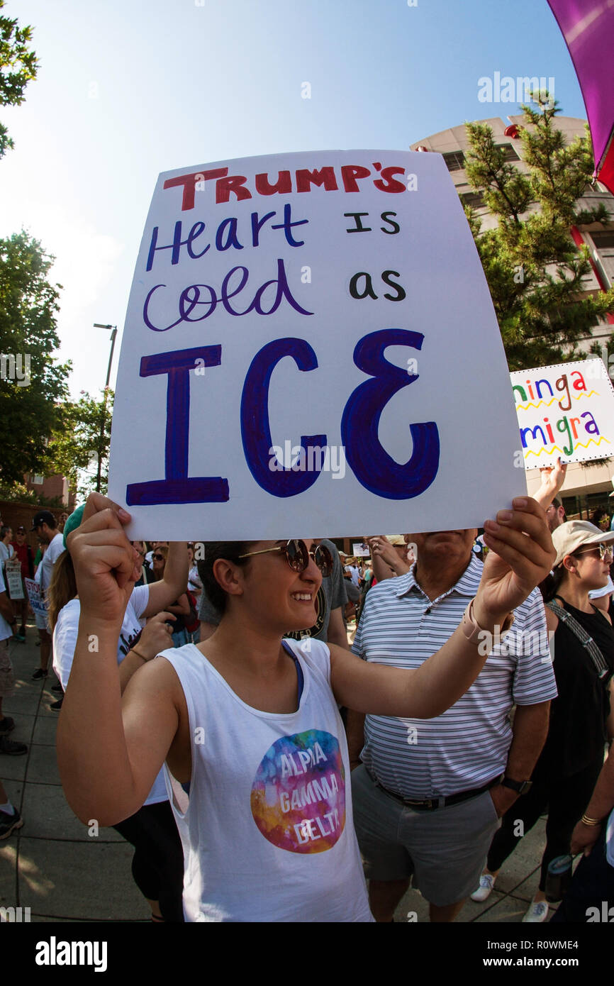 A woman holds a sign saying "Trump's heart is as cold as ICE" at an ...