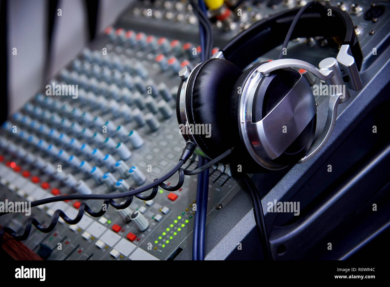 Headphones on a dj control panel close-up Stock Photo - Alamy