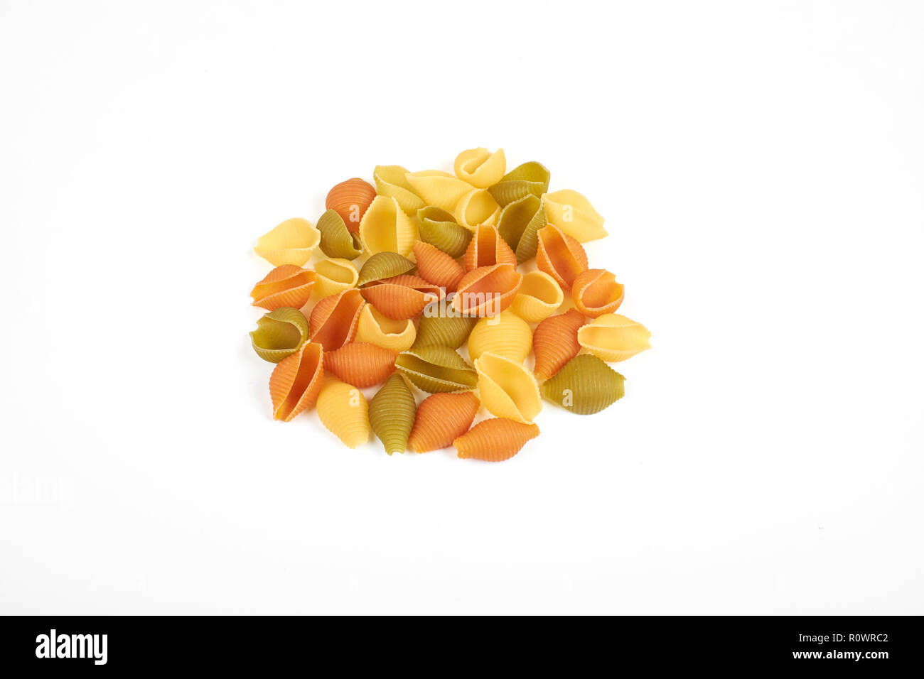 Shell pasta on white background, top view Stock Photo - Alamy