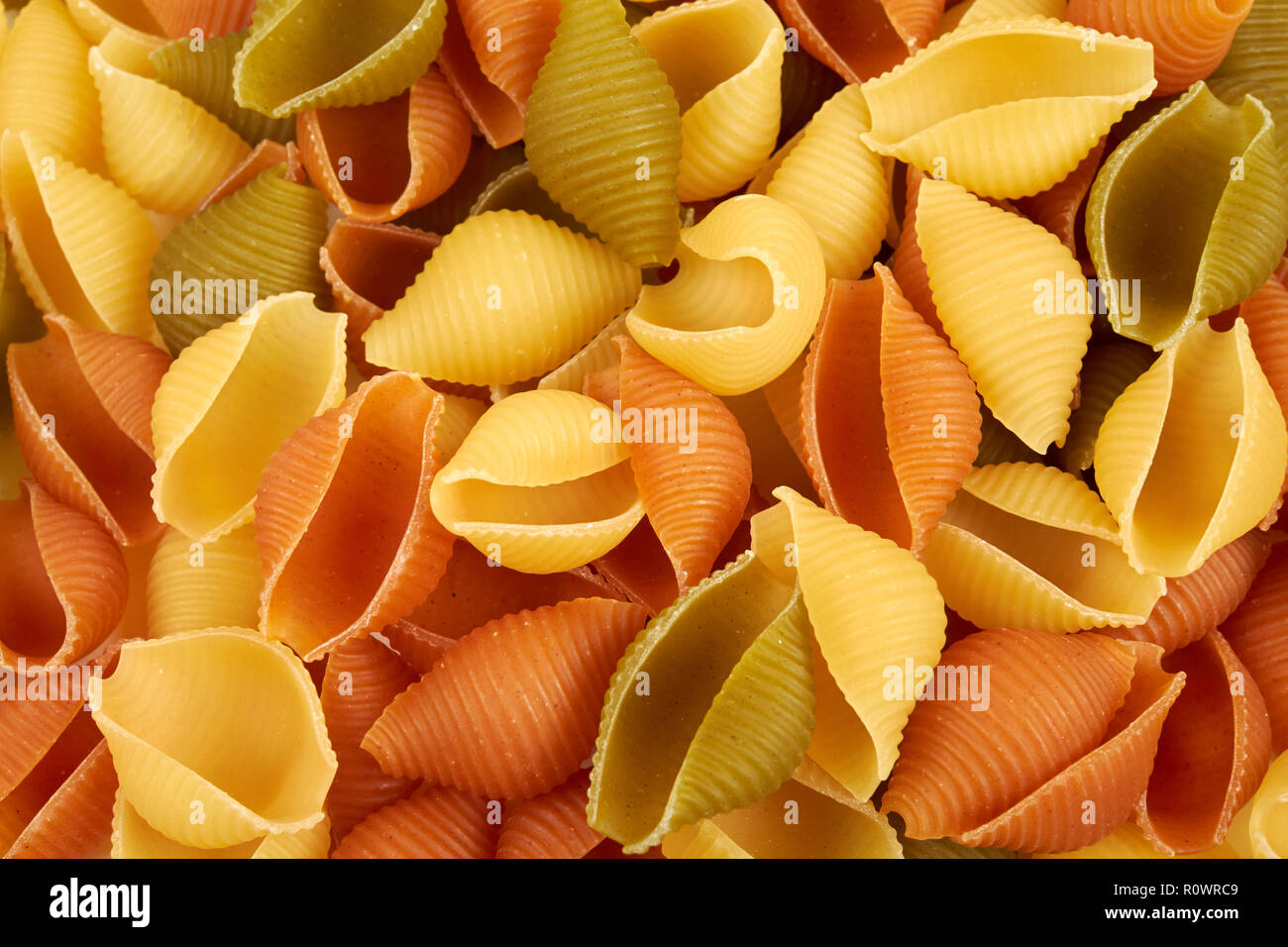 Shell pasta on white background, top view Stock Photo - Alamy