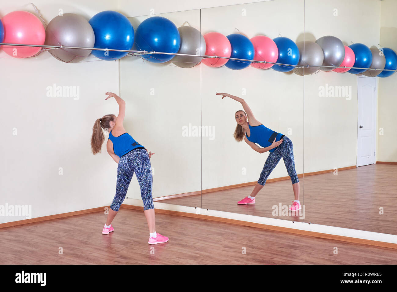 fitness woman, stretching her body ,before workout , in front of the ...