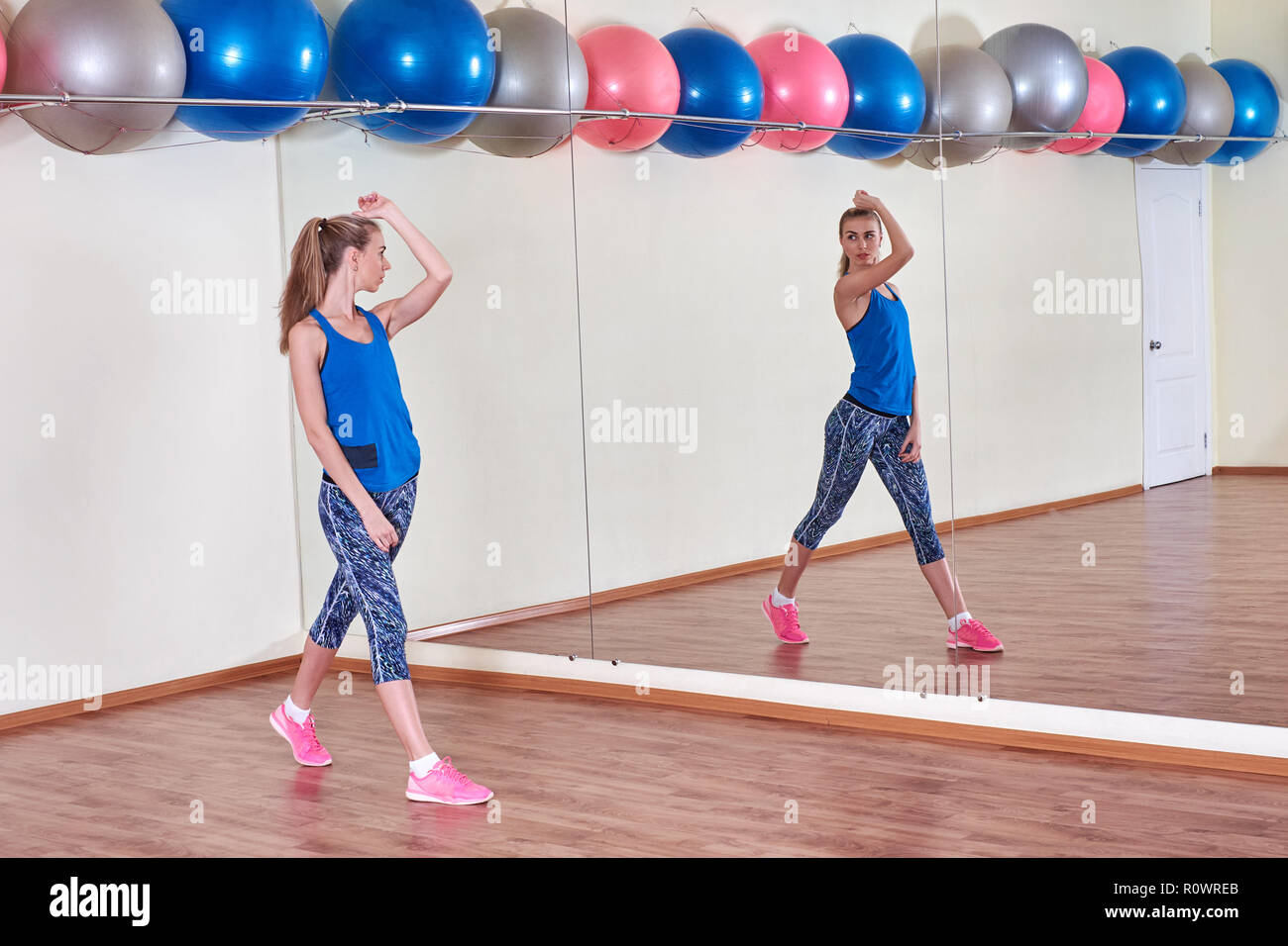 fitness woman, stretching her body ,before workout , in front of the ...