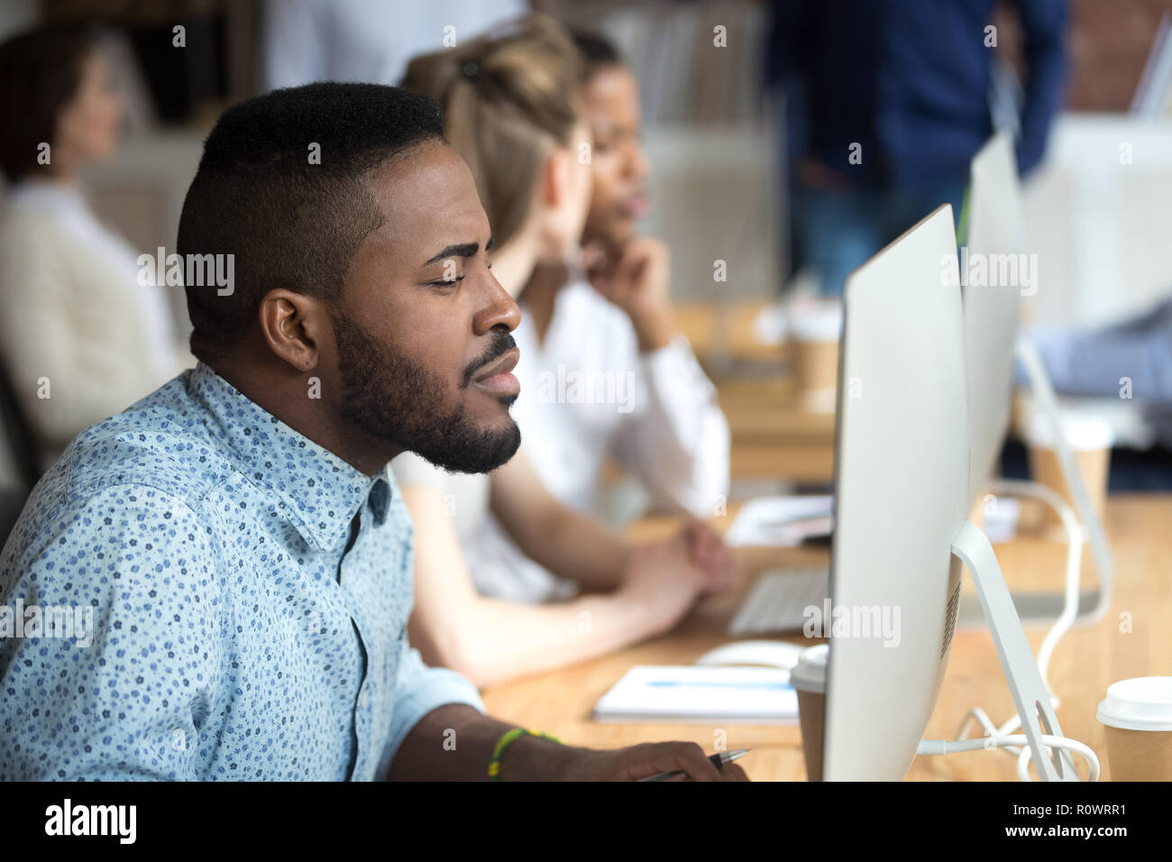 Thoughtful African American look at computer screen working Stock Photo ...