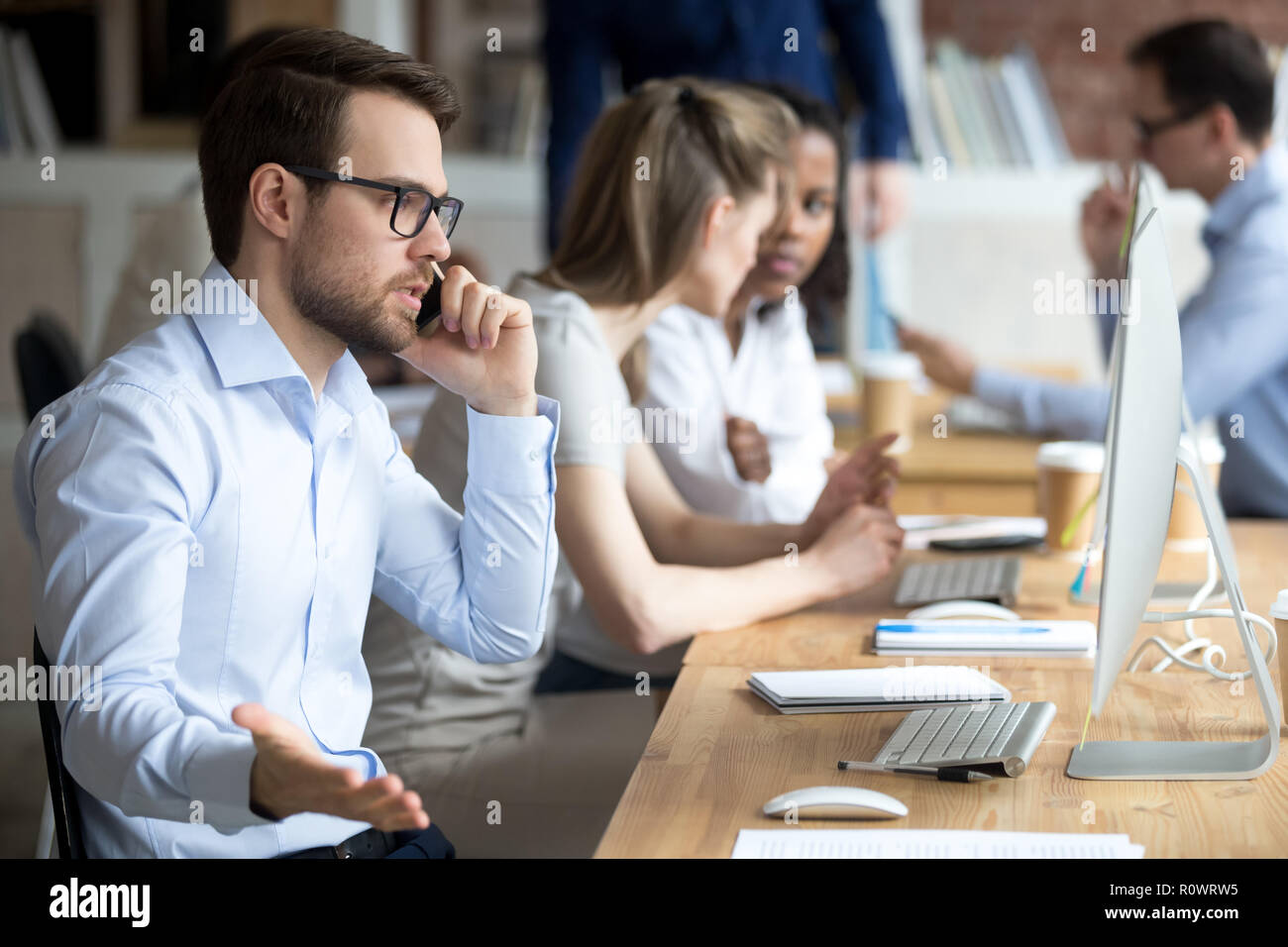 Angry male worker talk on phone solving business problems Stock Photo ...
