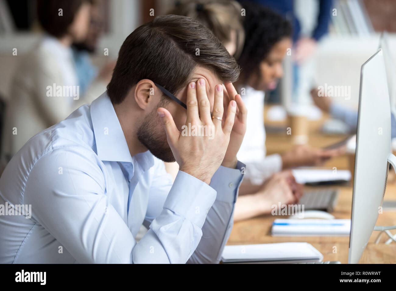 Nervous male employee feel anxious at workplace Stock Photo - Alamy