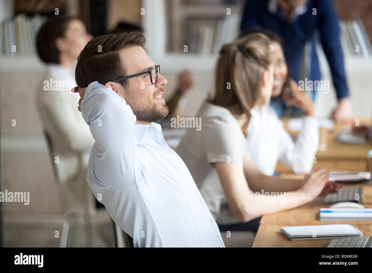 Happy male employee lean in chair dreaming of success Stock Photo - Alamy