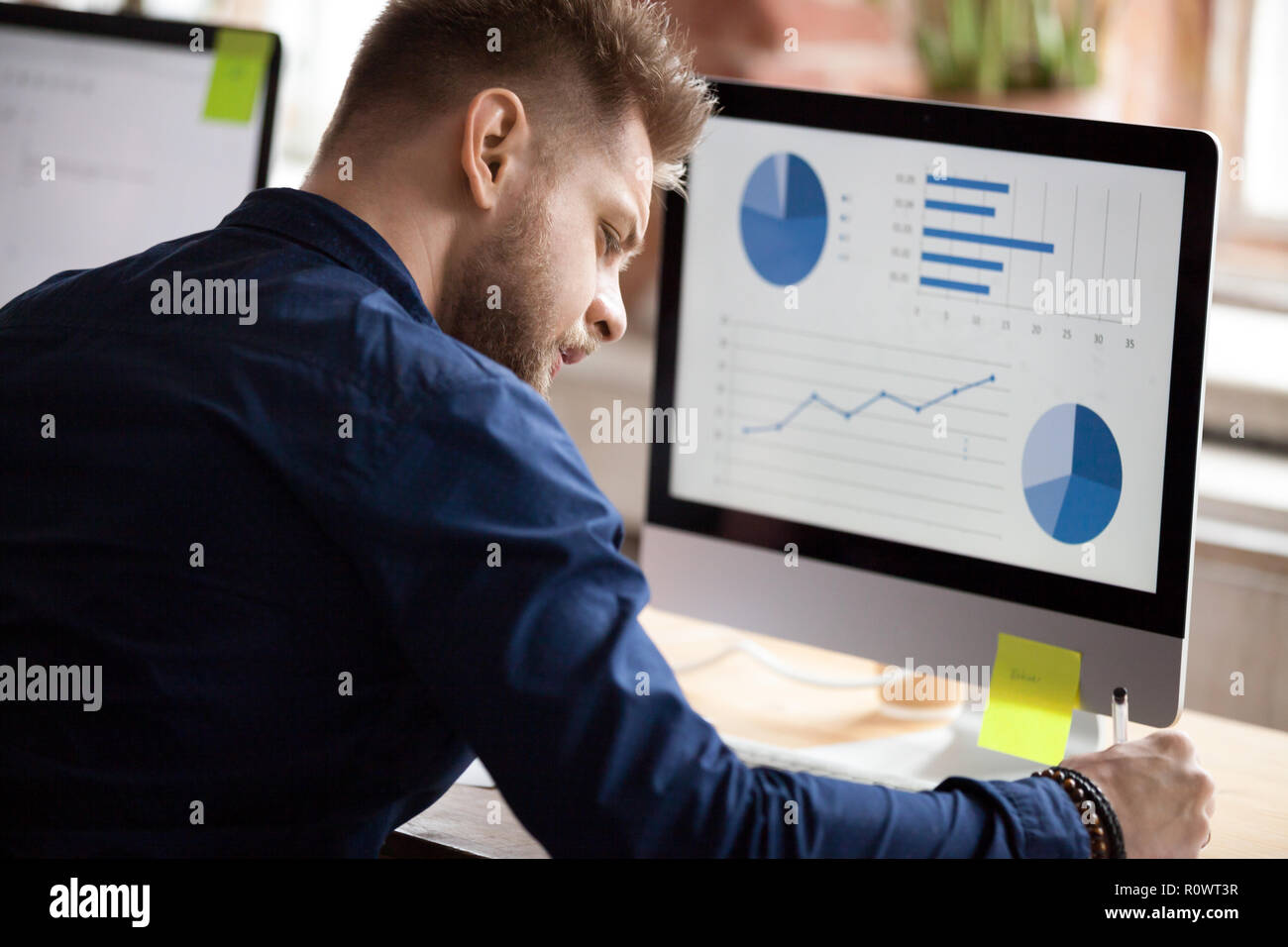 Businessman working on graphs hi-res stock photography and images - Alamy