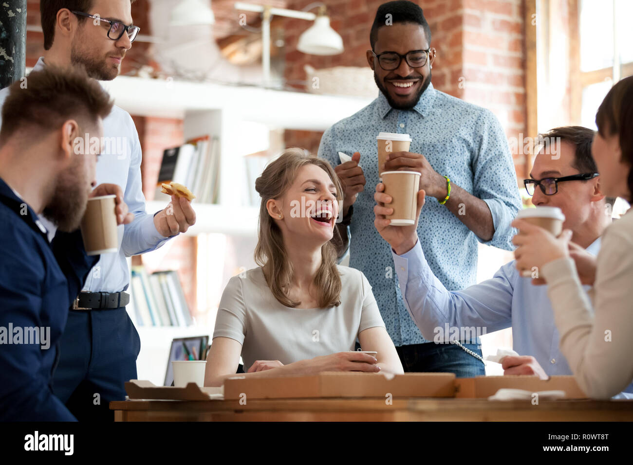 Happy Diverse Colleagues Celebrate During Lunch Break In Office Stock
