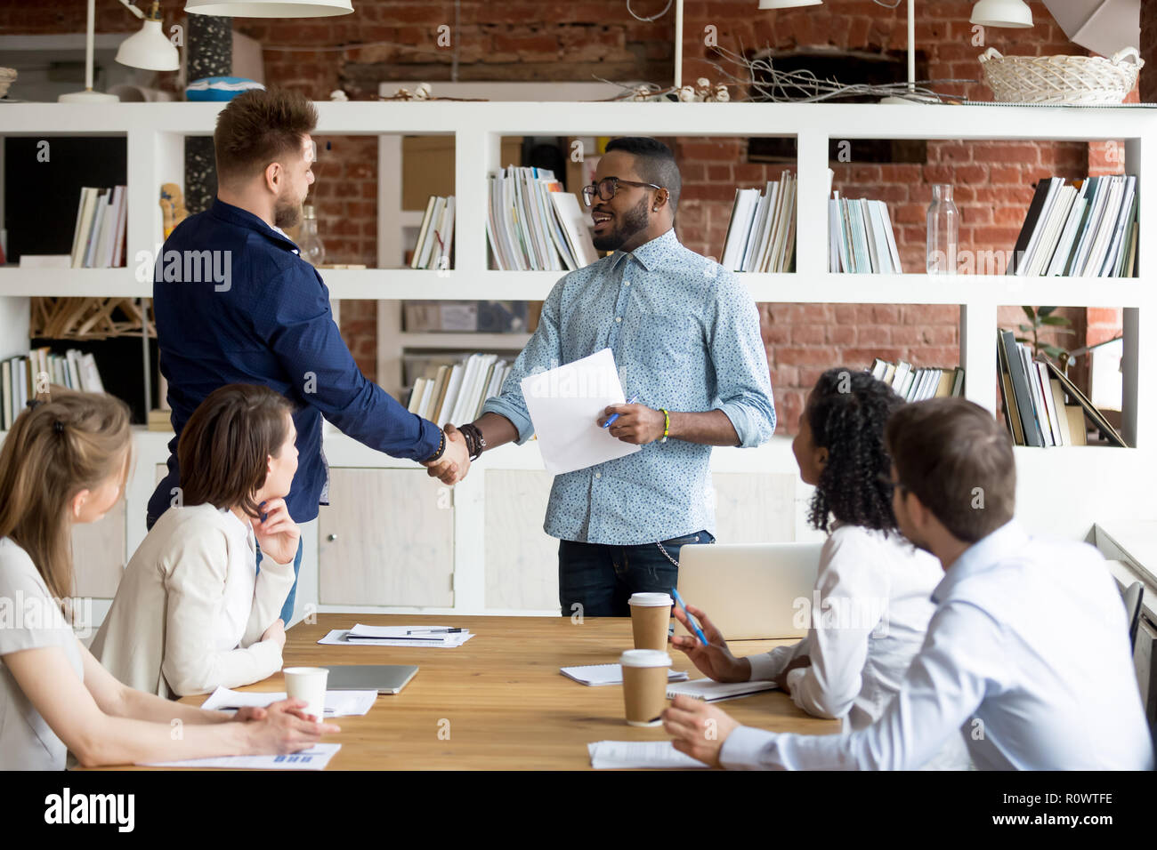 Team leader handshake make employee greeting with success Stock Photo ...