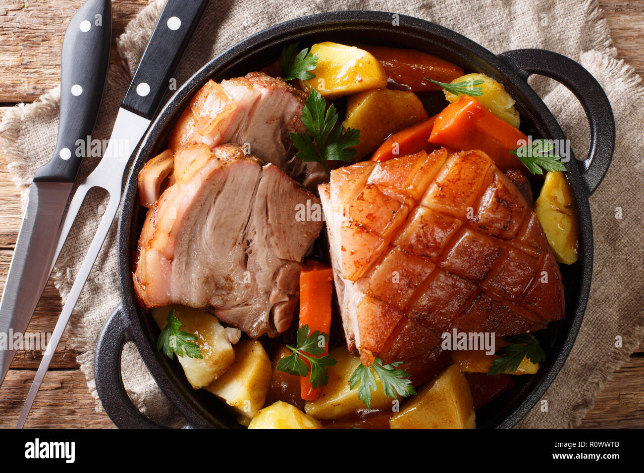 Krustenbraten Pork Roast with Crispy Rind with vegetables close-up in a ...